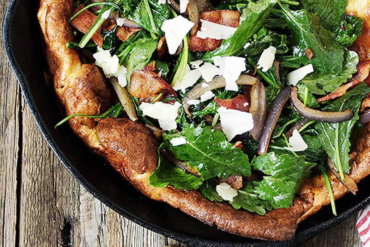 Kale Bacon and Aged Cheddar Dutch Baby - Seasons and Suppers